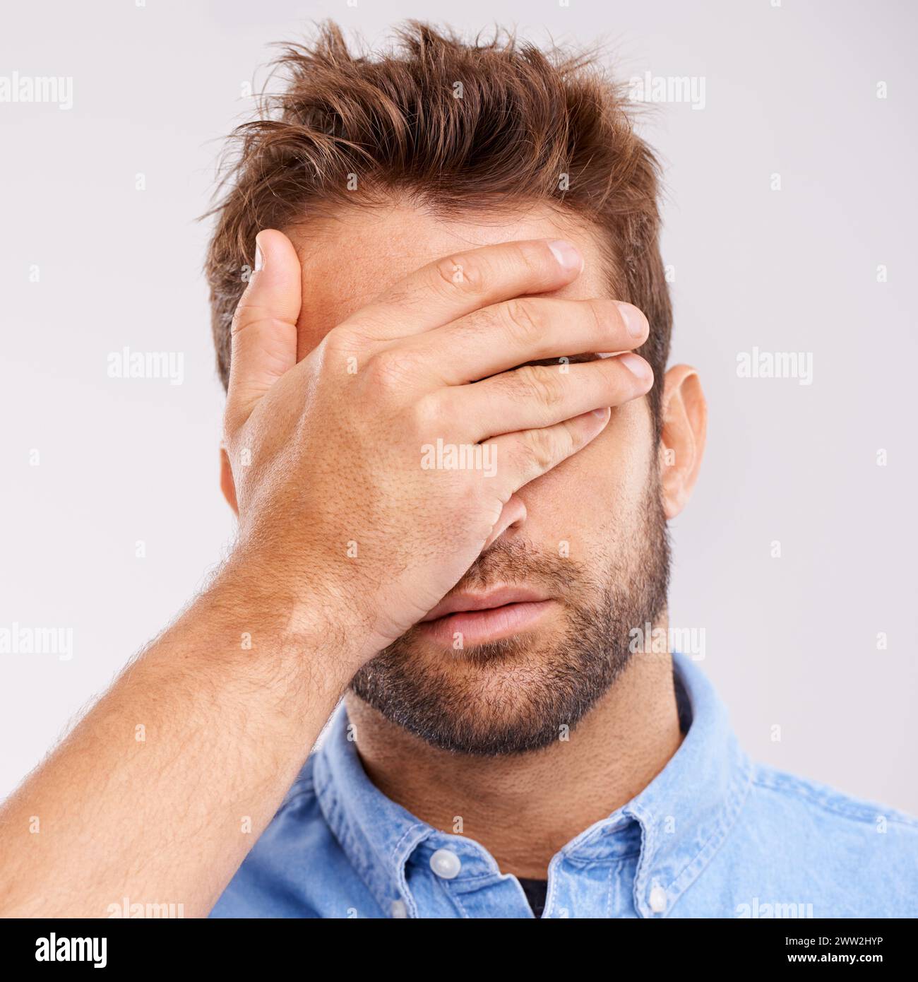 Regret, stress and face of man in studio with embarrassment, thinking ...