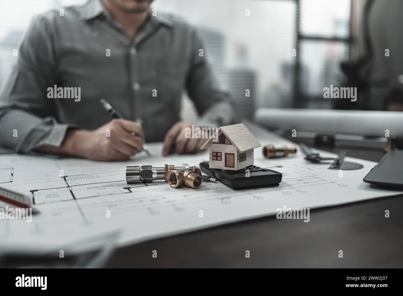 Mini model house on calculator and them on blueprint house plan design ...