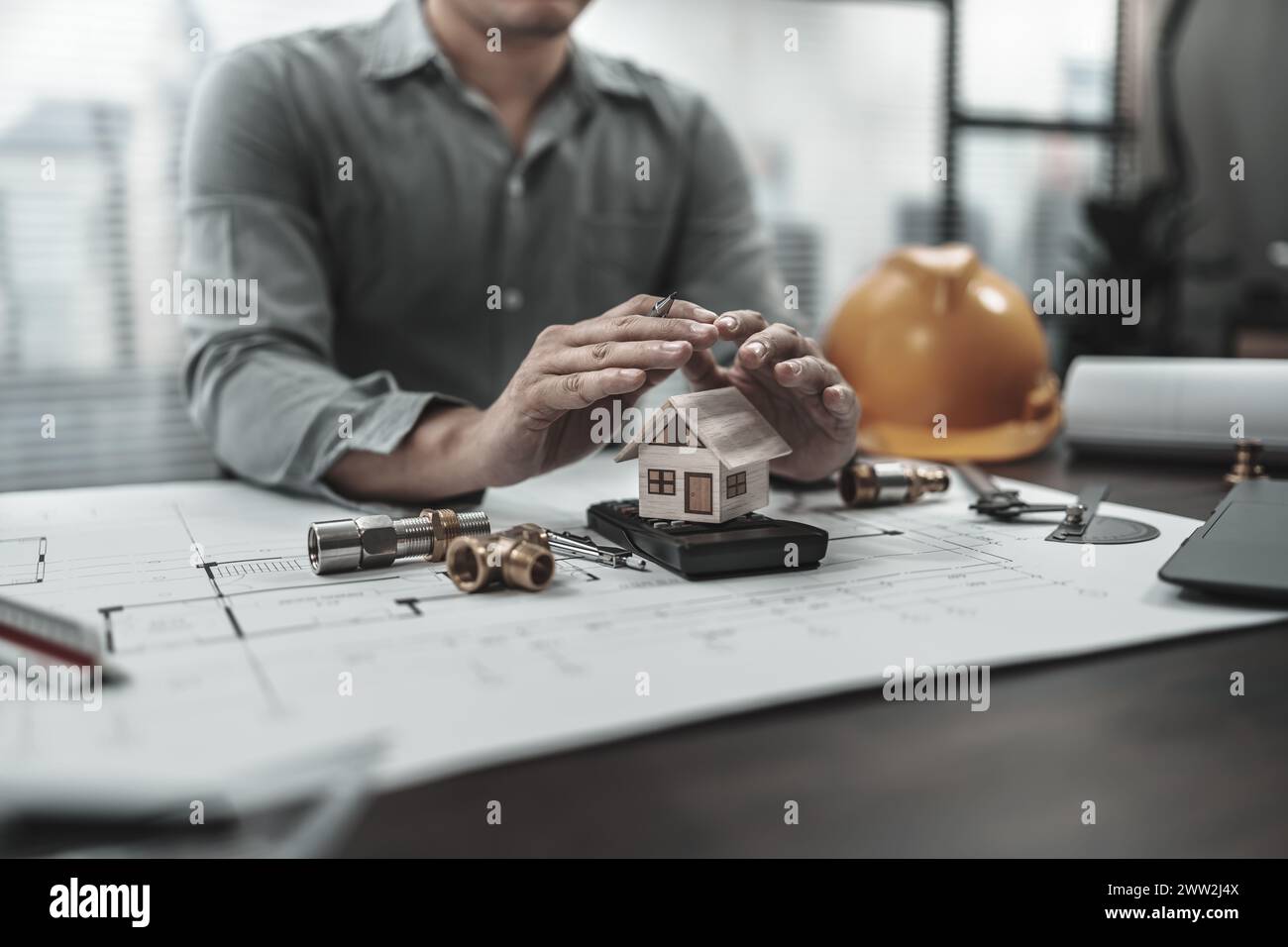 Architect engineer hands hold and protect mini house model on blueprint. Sell, Protect House ...