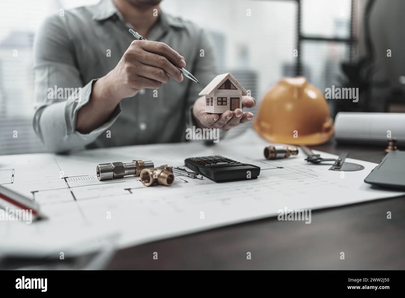 Architect engineer hands hold and protect mini house model on blueprint. Sell, Protect House ...