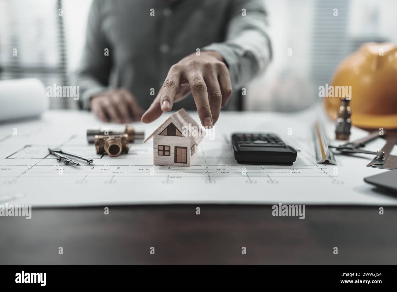 Architect engineer going to pick up mini house model on blueprint. Sell, Protect House, cost ...