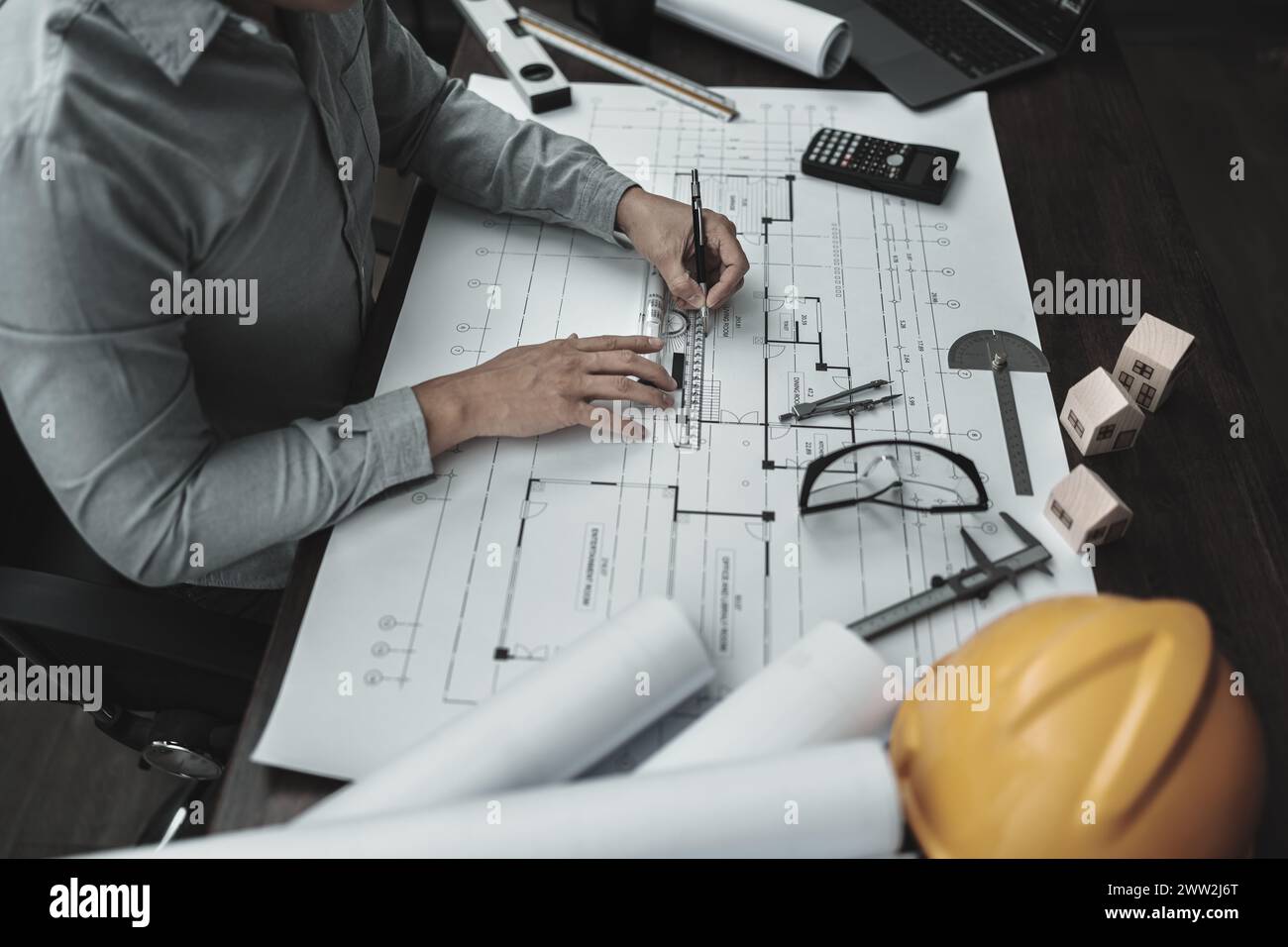 Architect engineer use pen and mini T-slide drawing design working on ...