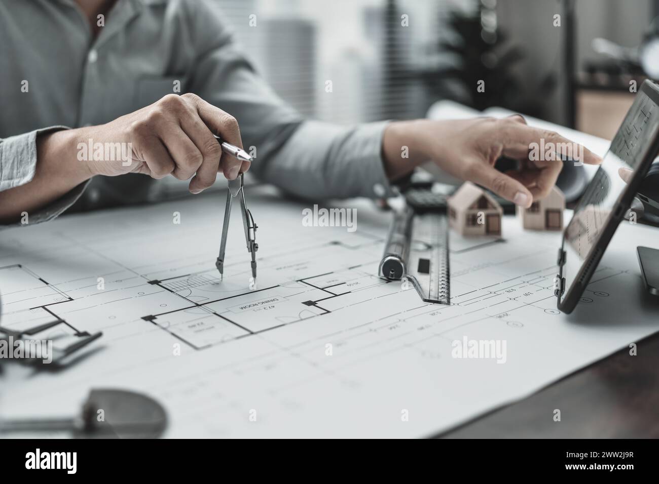 Architect using divider compass working on blueprint. House planning ...