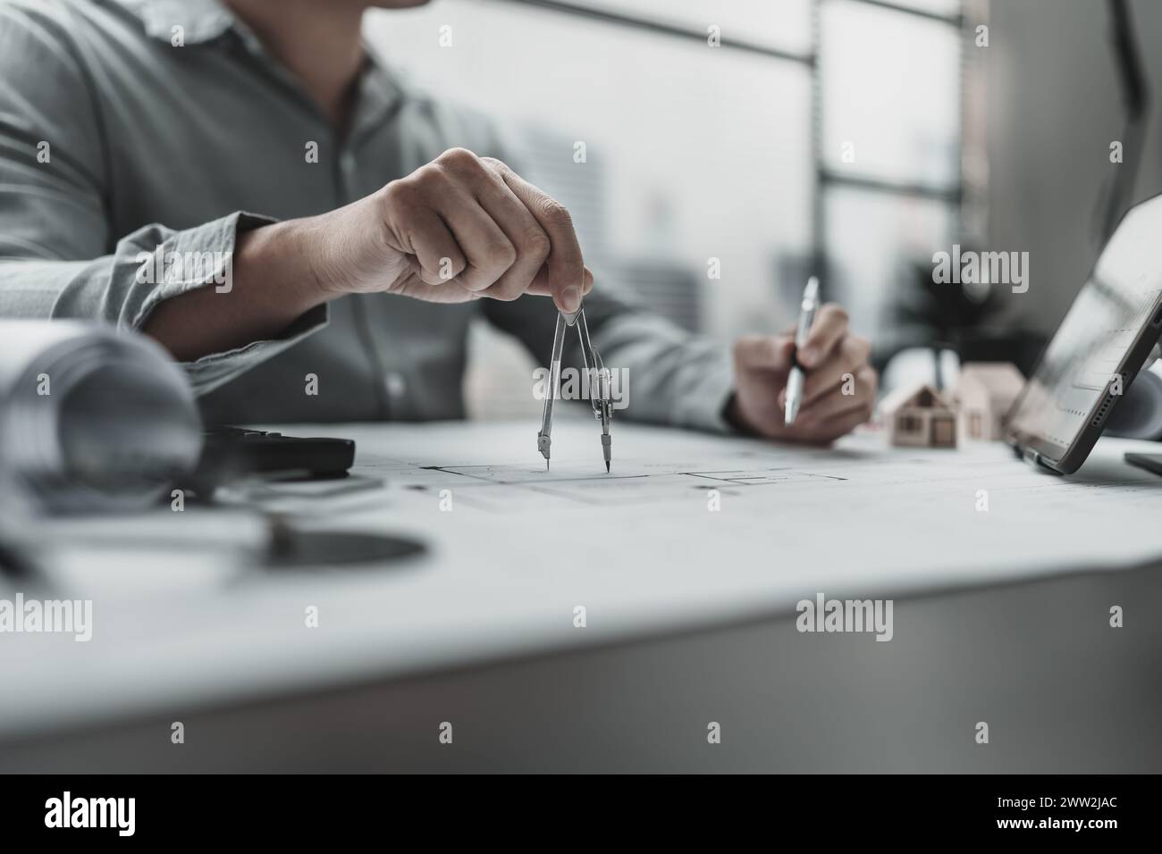 Architect using divider compass working on blueprint. House planning ...