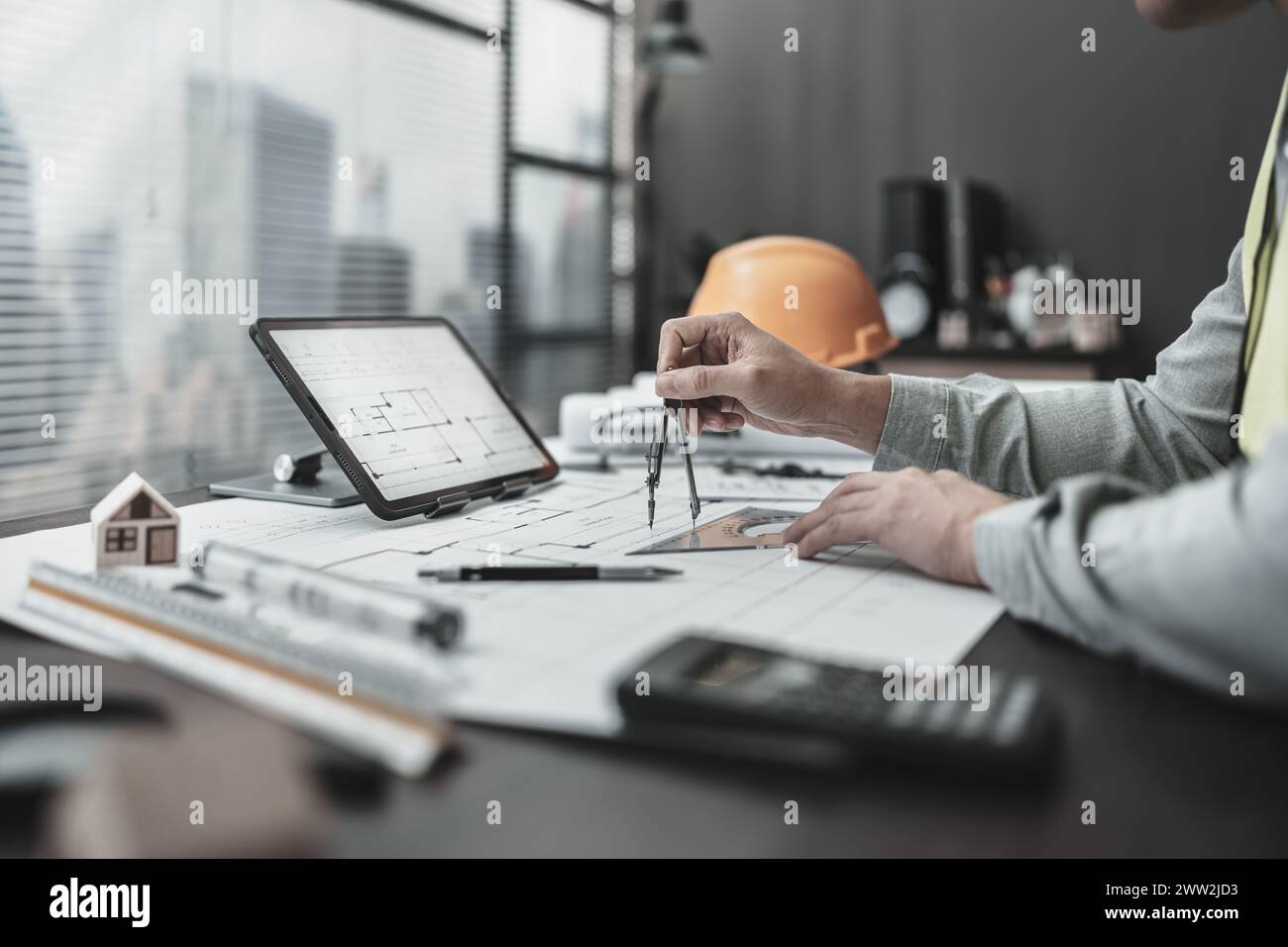 Architect using divider compass working on blueprint. House planning ...