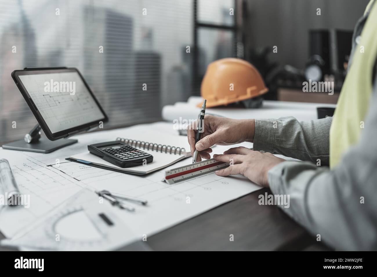 Engineering working with drawings inspection and writing on the office ...