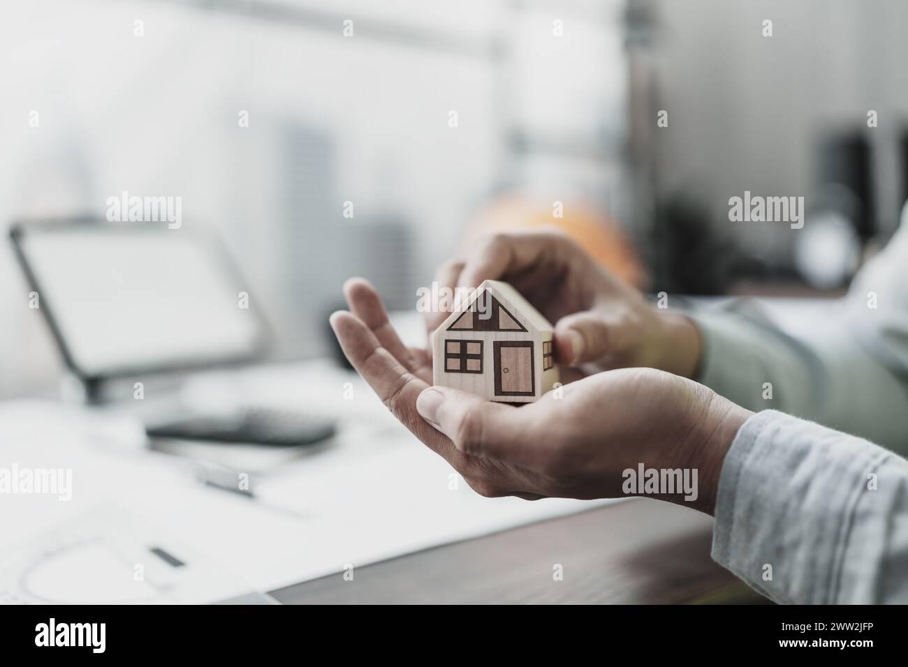 Architect engineer hands hold and protect mini house model on blueprint. Sell, Protect House ...