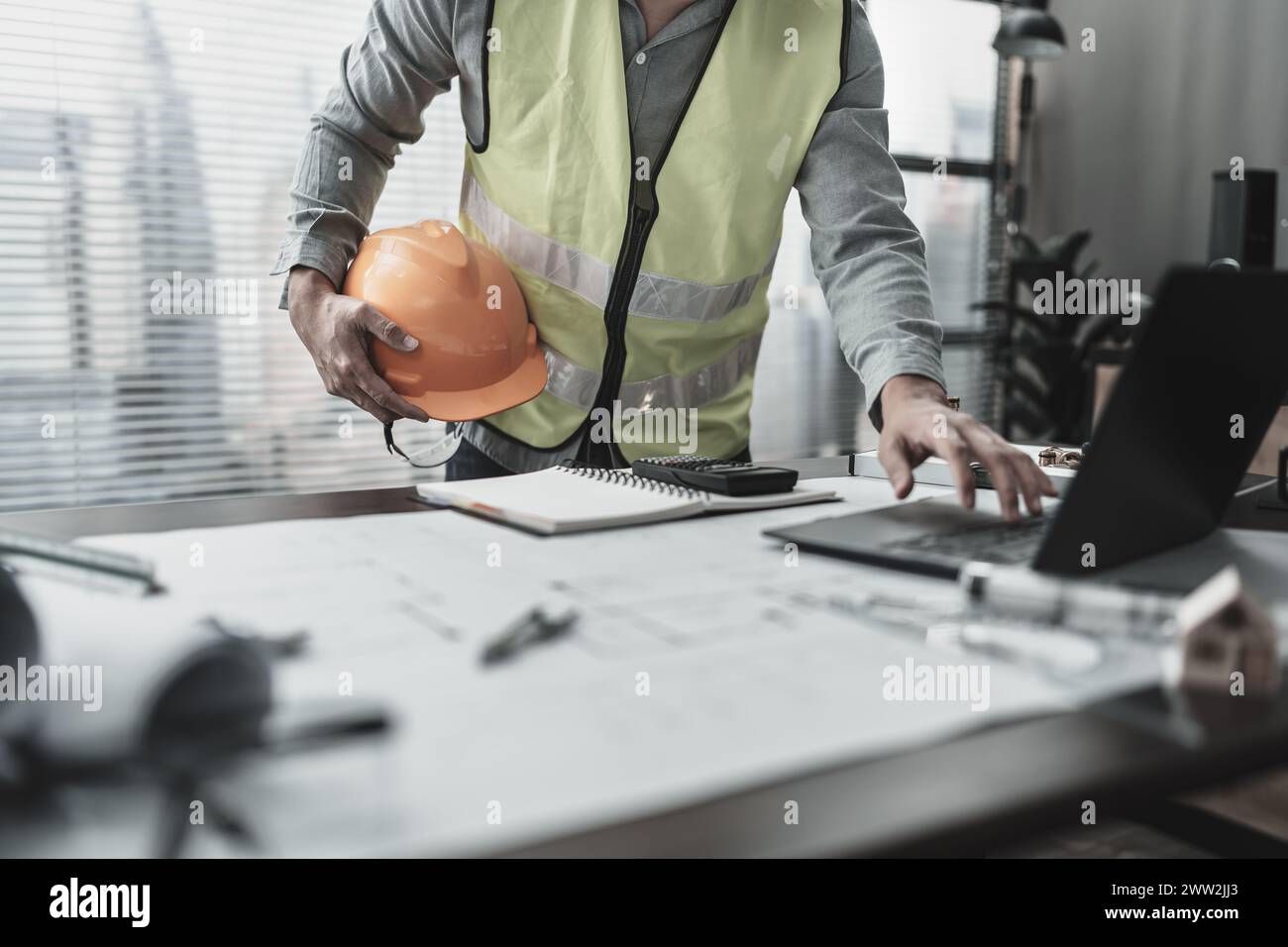 Engineering hold safety helmet working with laptop inspection on the ...