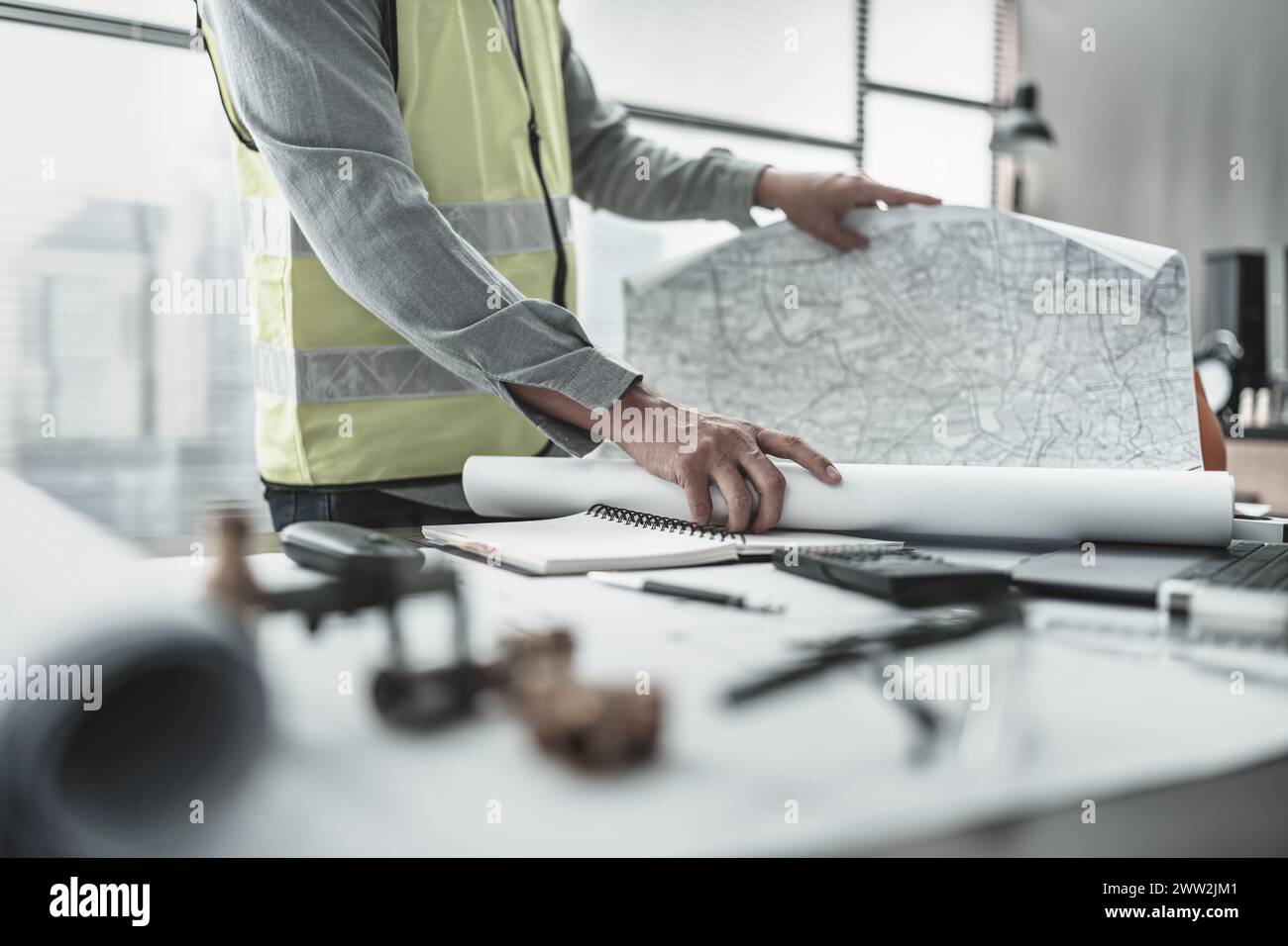 Architect, engineer planning and reading on city map and marking a ...