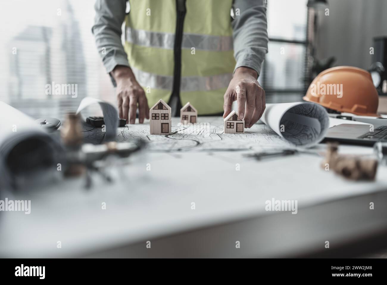 Model house and wood doll are repersent family on city map in front of ...