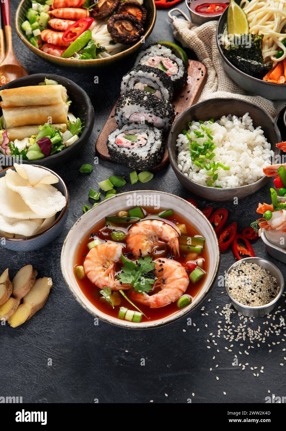 Traditional Asian food table. Spring roll, rice, shrimp, sushi ...