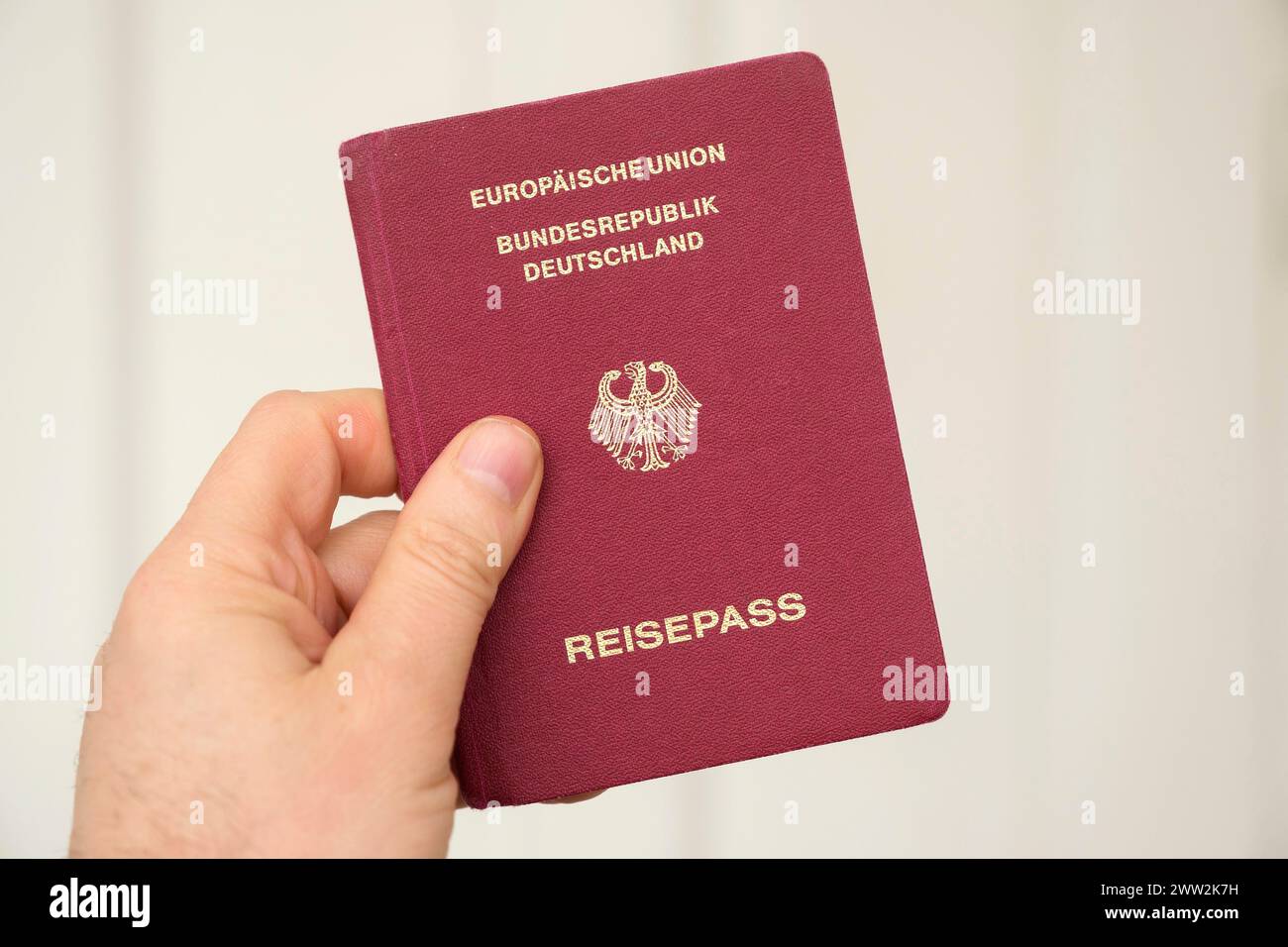 Hand holding a German passport Stock Photo - Alamy