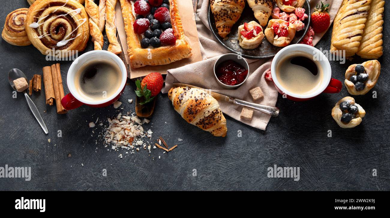 Different tasty freshly baked pastries on dark background. Top view ...