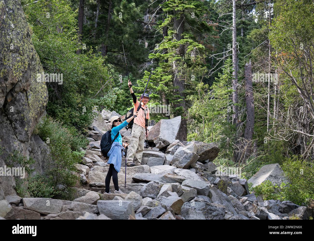 Couple raising hiking poles and enjoying the views at Eagle Lake trail ...