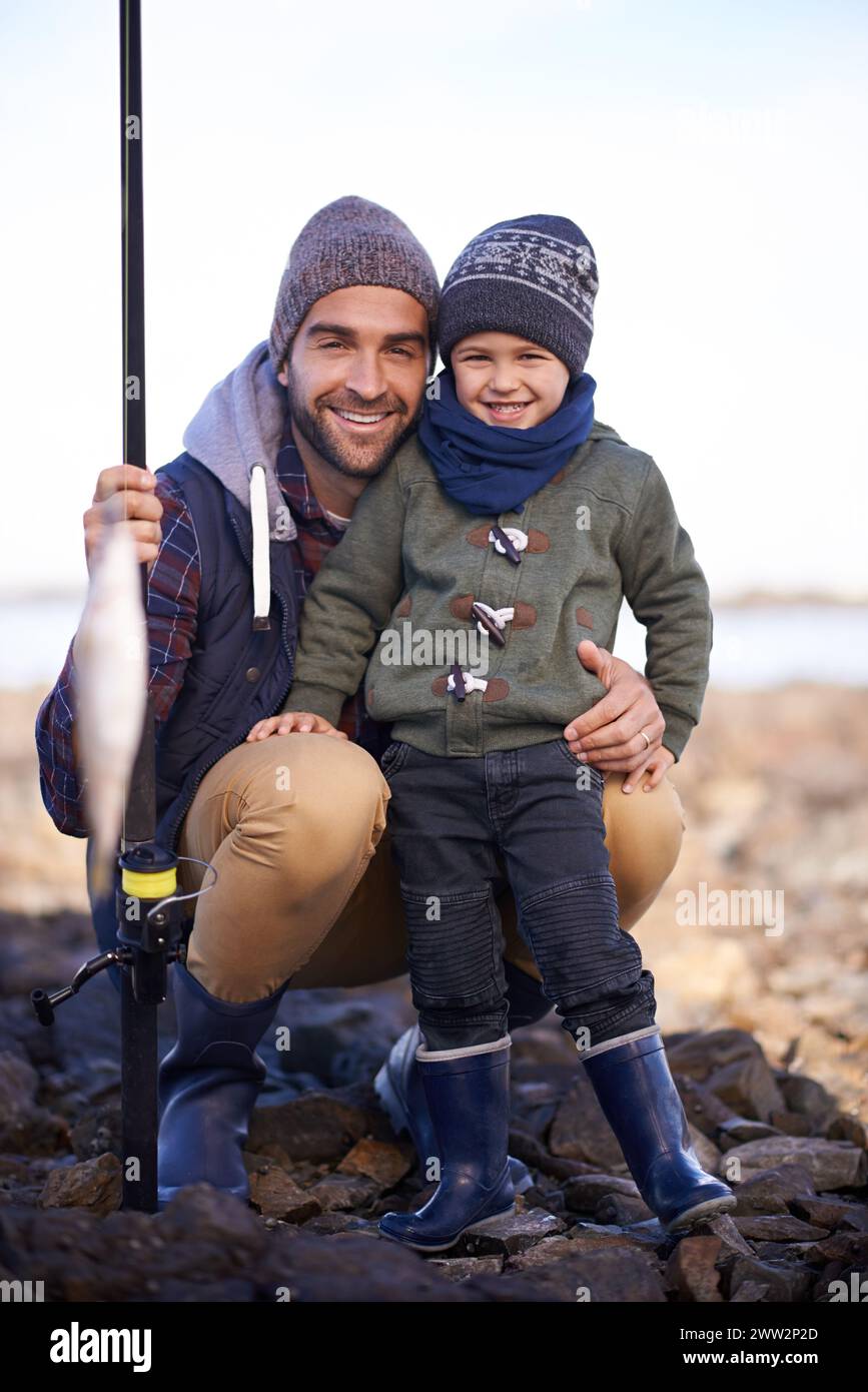 Portrait, kid and smile with dad, fish and happiness for achievement on ...