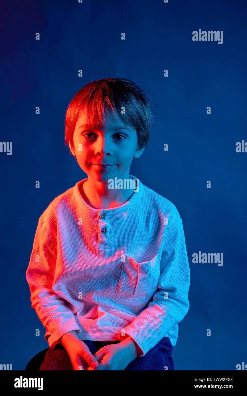 Artistic portrait of a child, boy, lightened with gel filters, studio ...