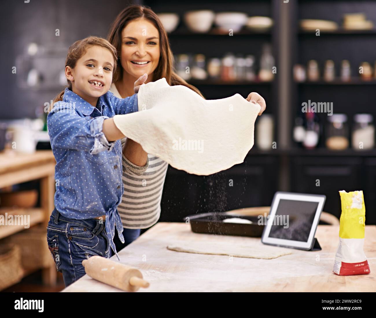 Portrait, mother or child baking pizza in a kitchen teaching recipe for ...