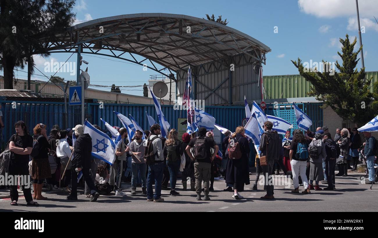 Right-wing activists hold Israeli flags and signs as they chant slogans ...