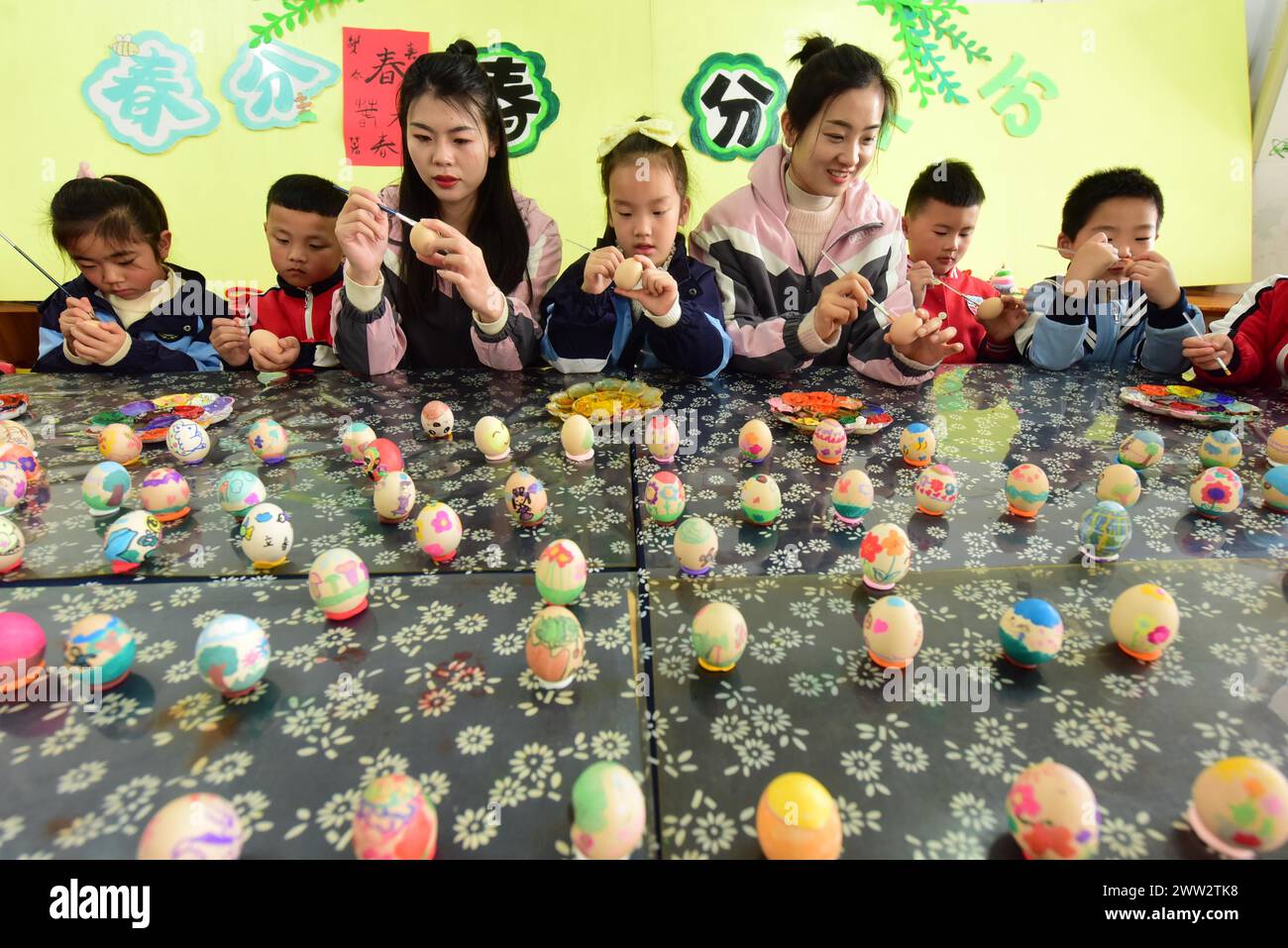Children at a kindergarten paint eggs to welcome the spring equinox in ...