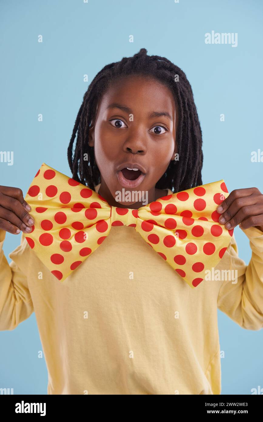 Child, bowtie and portrait in studio for costume, clothes and fashion for silly, comic and bold ...