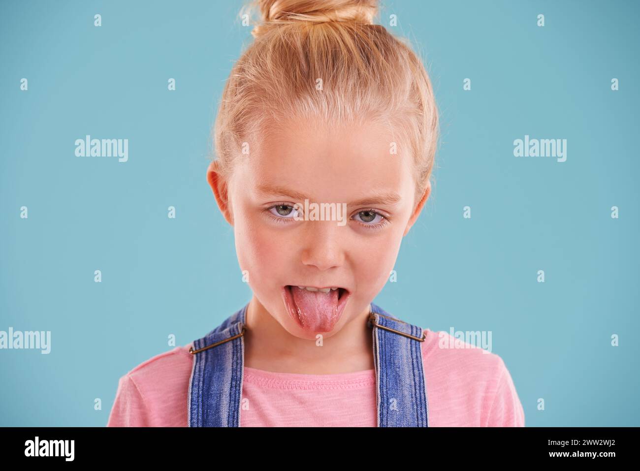 Kid, portrait and tongue out in studio for silly, goofy and playful ...