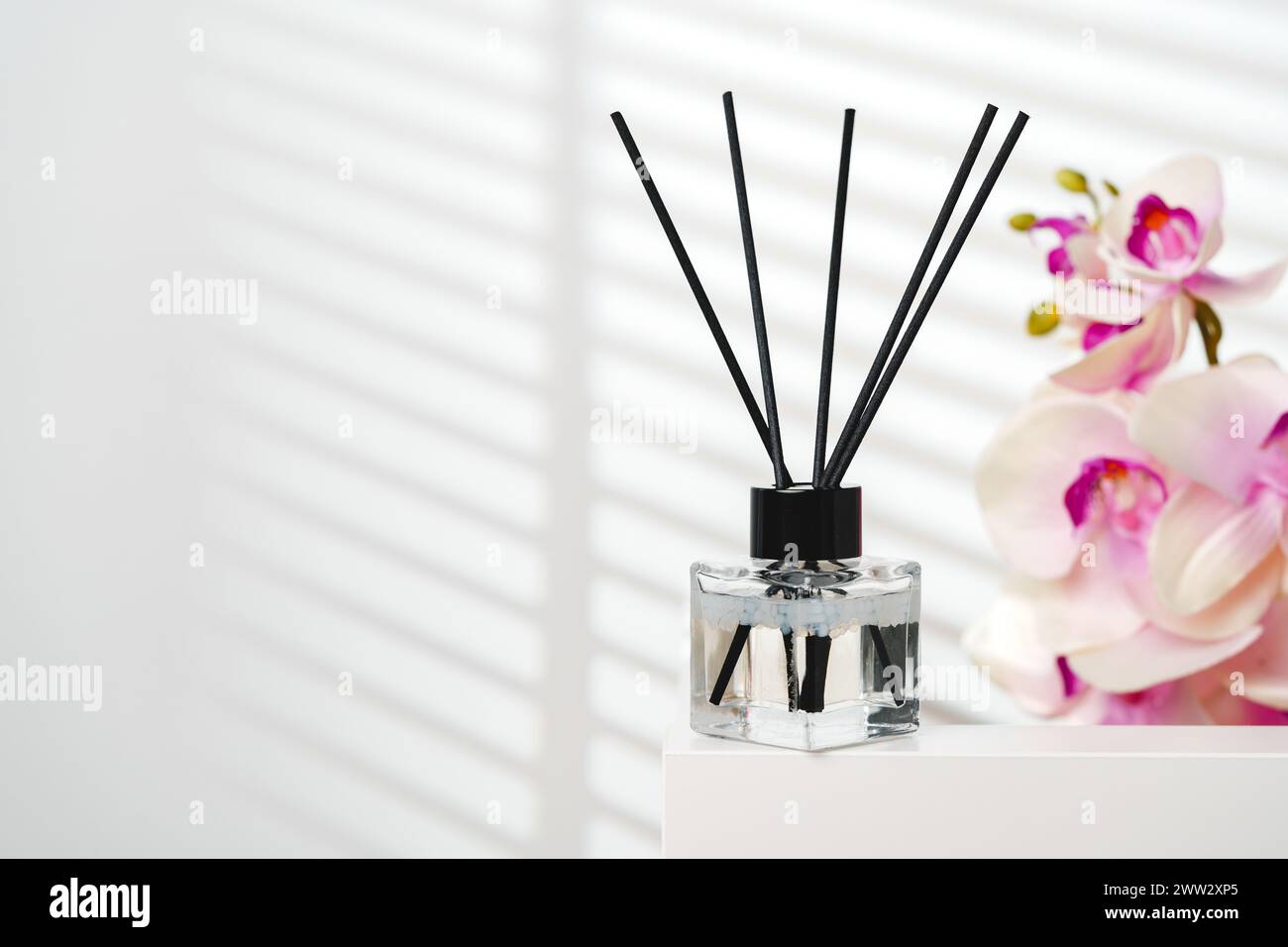 Elegant Reed Diffusers Beside Blooming Orchids in a Bright Interior ...