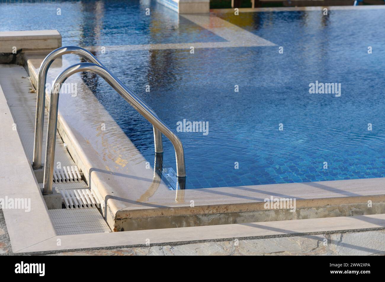 Grab bars ladder in the blue swimming pool 1 Stock Photo - Alamy