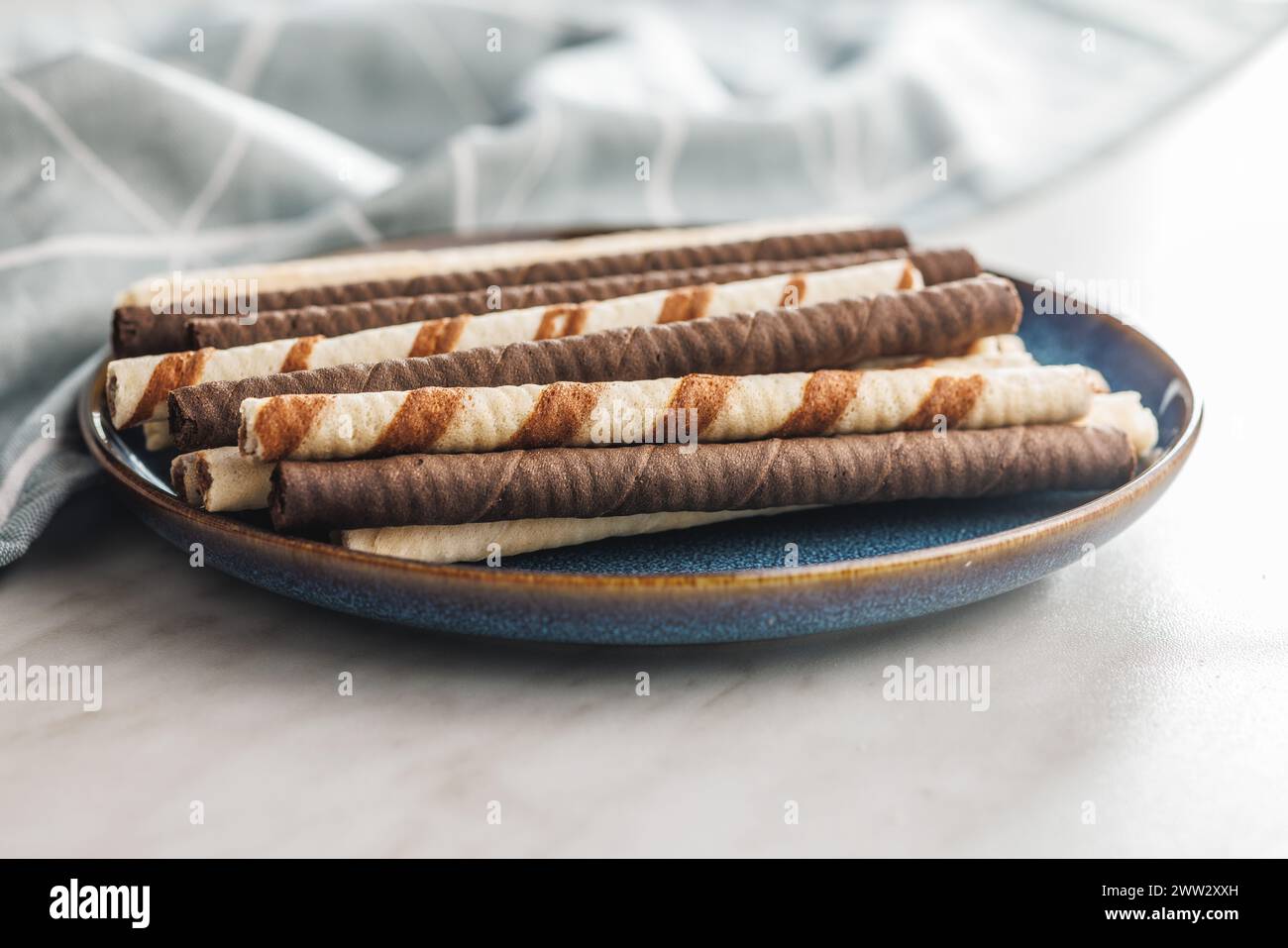 Assorted Chocolate and Vanilla Cream Filled Wafer rolls on plate on a ...