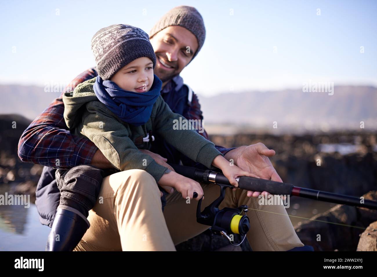 Father, kid and fishing at sea in winter as hobby with bonding for child development, growth and ...