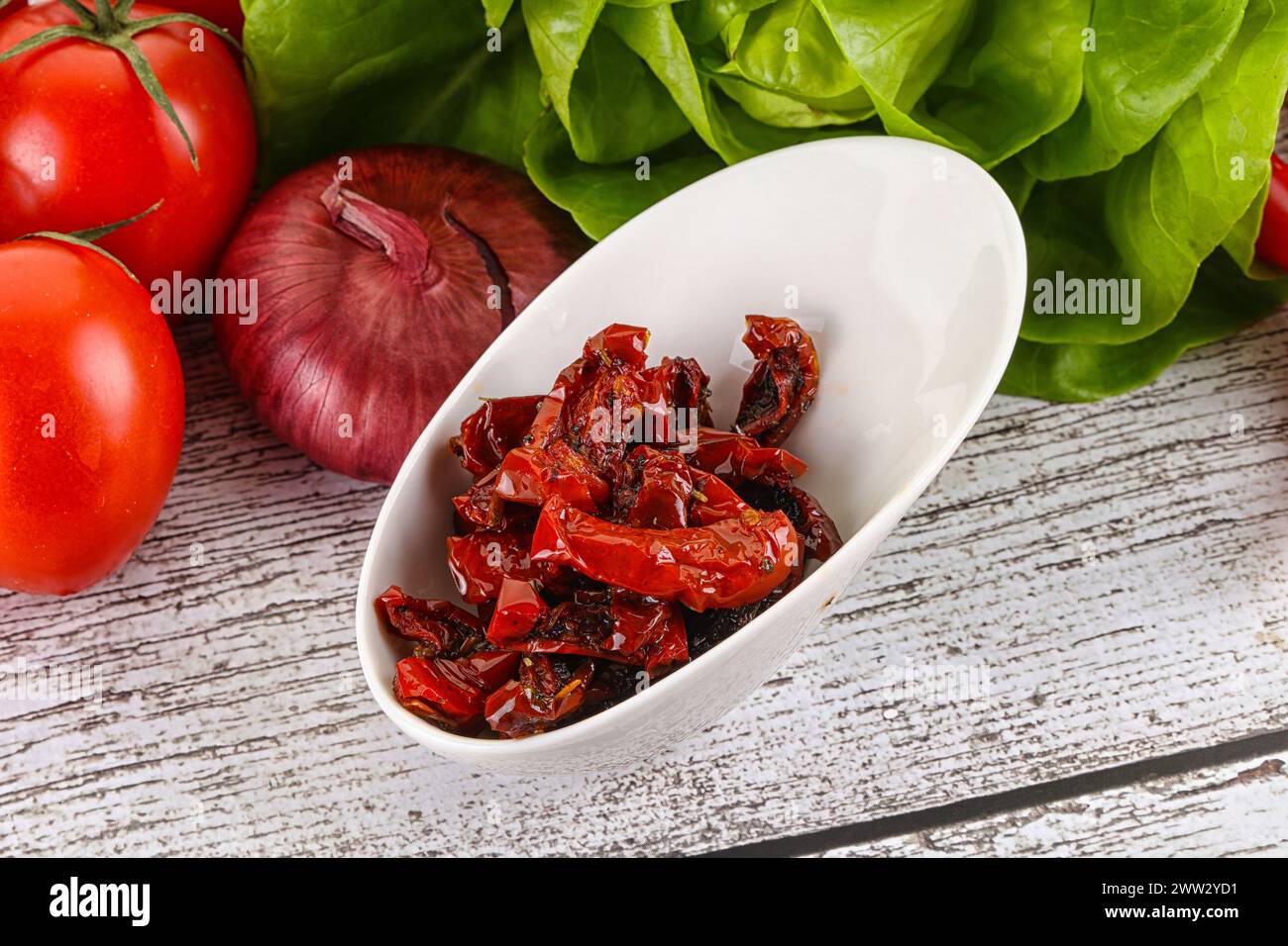 Dry tomato with olive oil in the bowl Stock Photo - Alamy