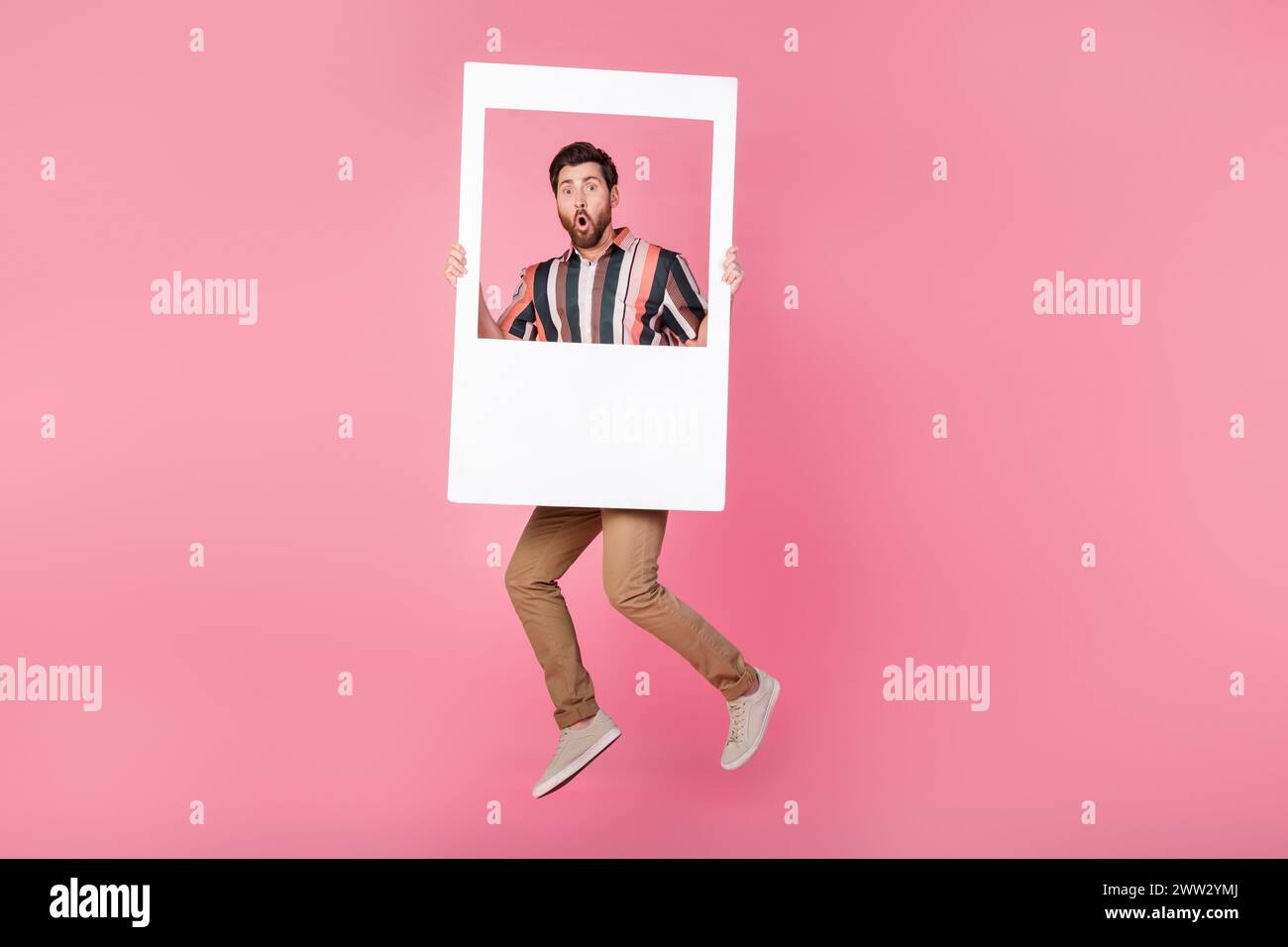 Full body length photo of jumping trampoline man holding astonished ...