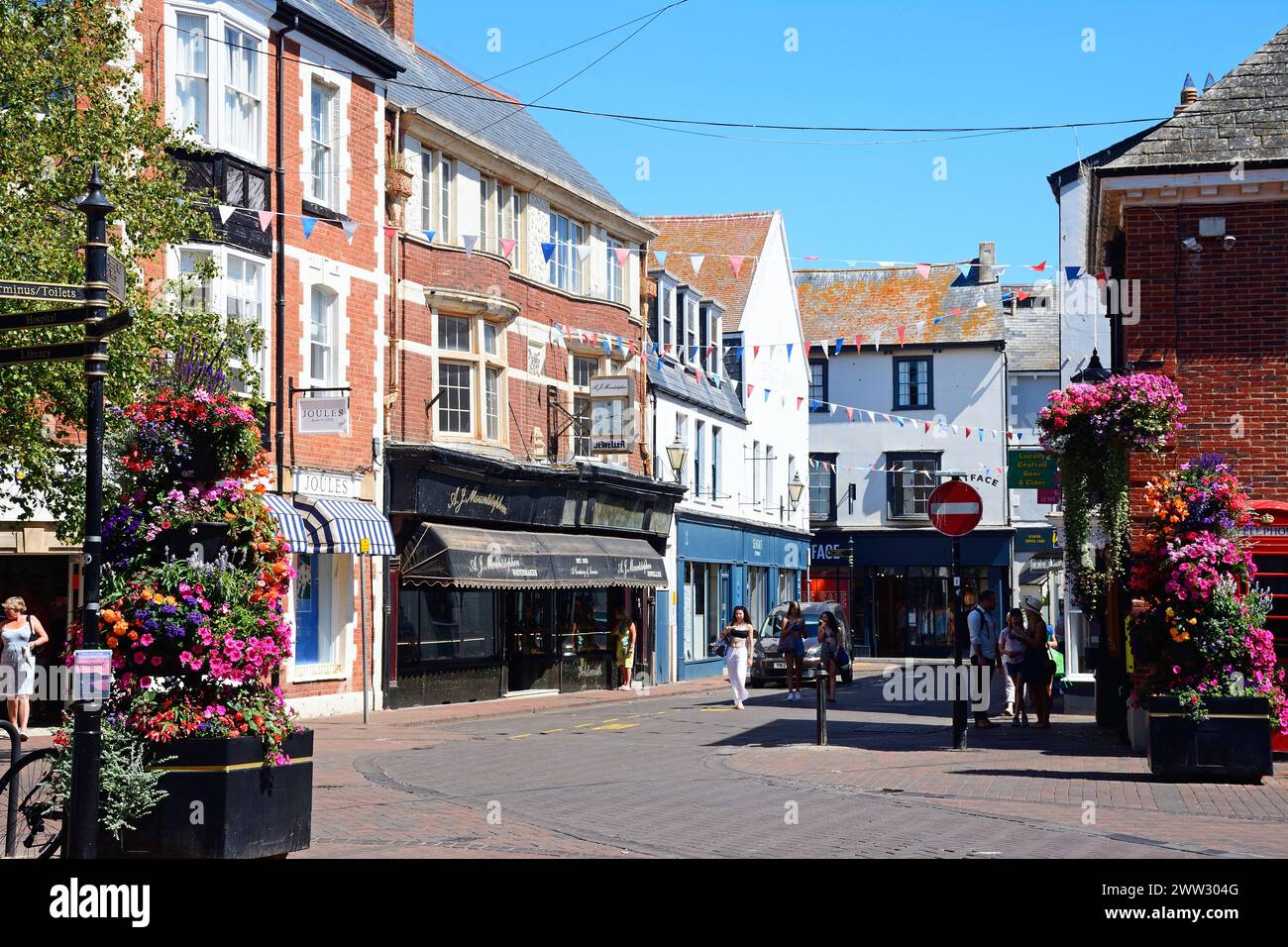 Tourists walking past shops in the old town, Sidmouth, Devon, UK ...