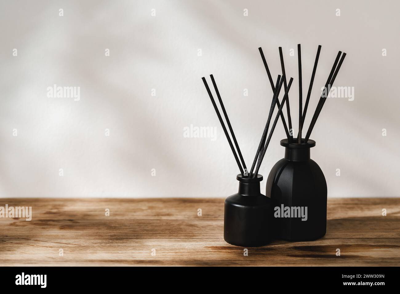 Minimalist Aromatic Reed Diffusers on a Wooden Surface Against a Soft ...