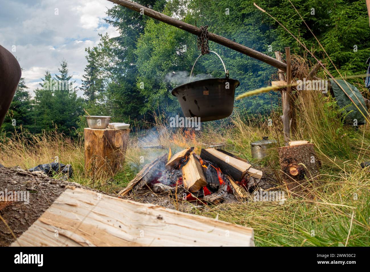 Cooking at campfire with adventure Stock Photo - Alamy
