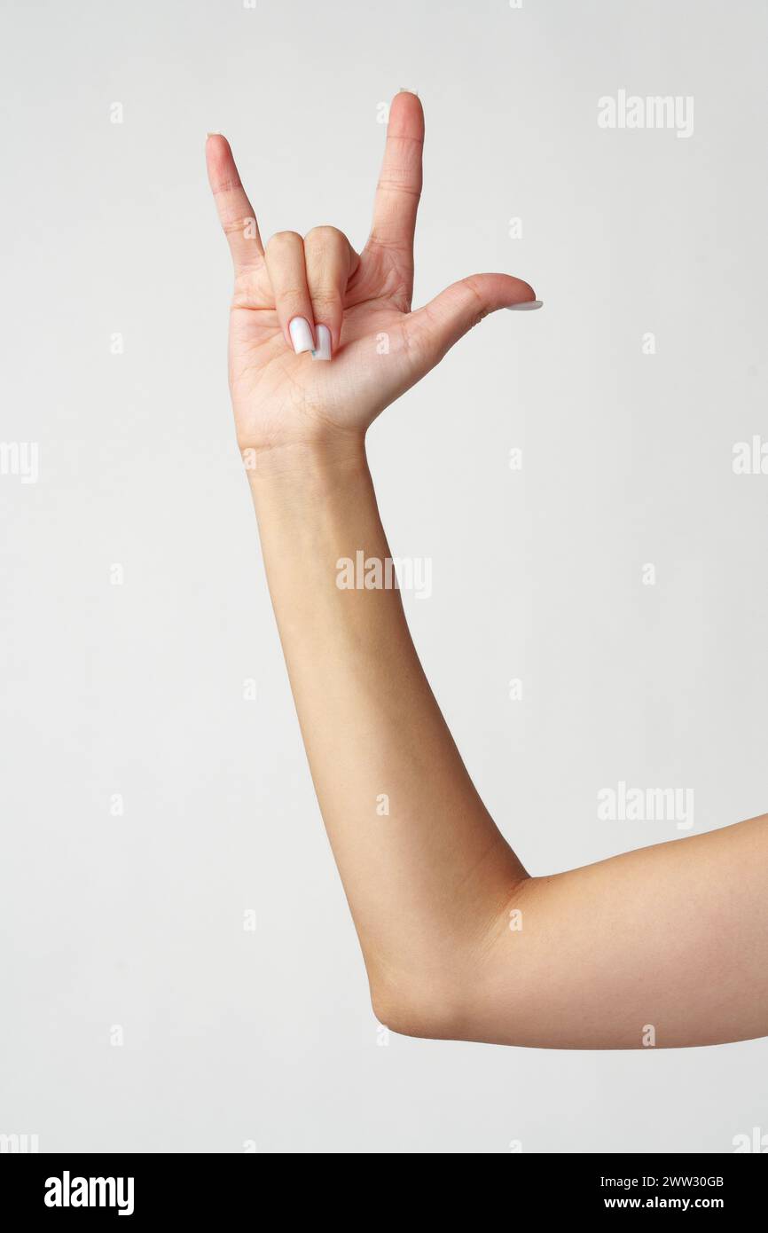 Female hand gesturing rock and roll on white background Stock Photo - Alamy