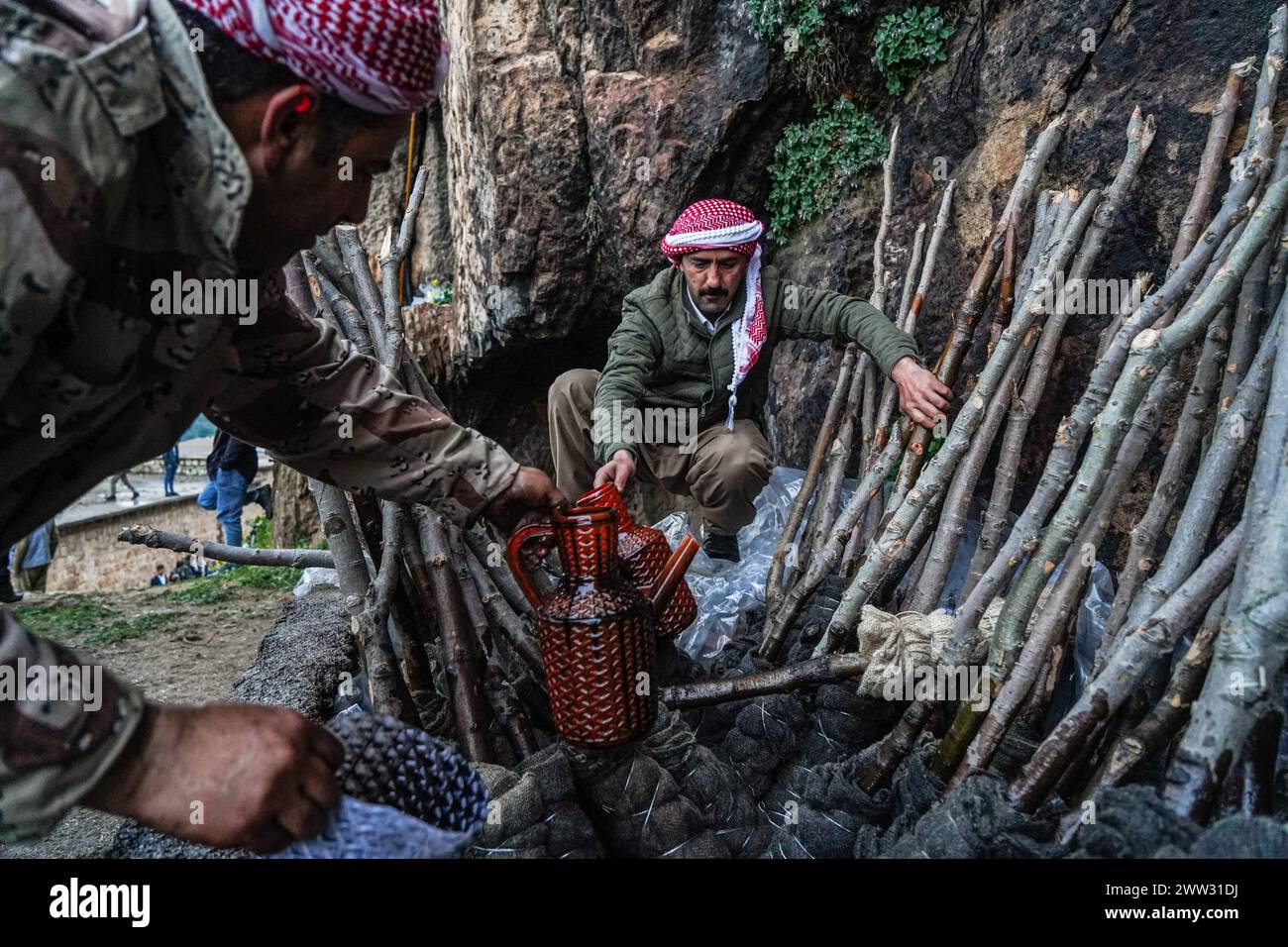 Akre, Iraq. 20th Mar, 2024. Iraqi Kurds prepare fire torches as they ...