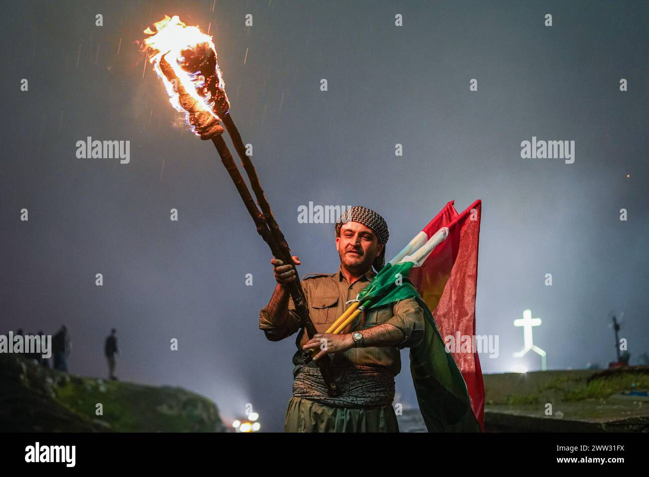 Akre, Iraq. 20th Mar, 2024. An Iraqi Kurdish man carries a fire torch ...