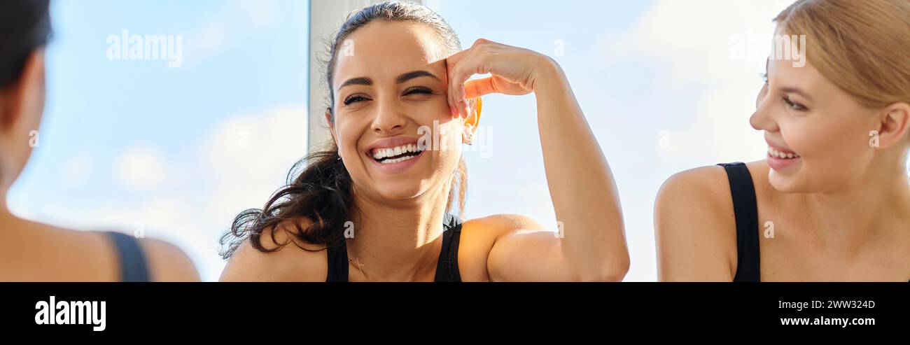 sunlight on face of happy brunette woman in active wear laughing after ...