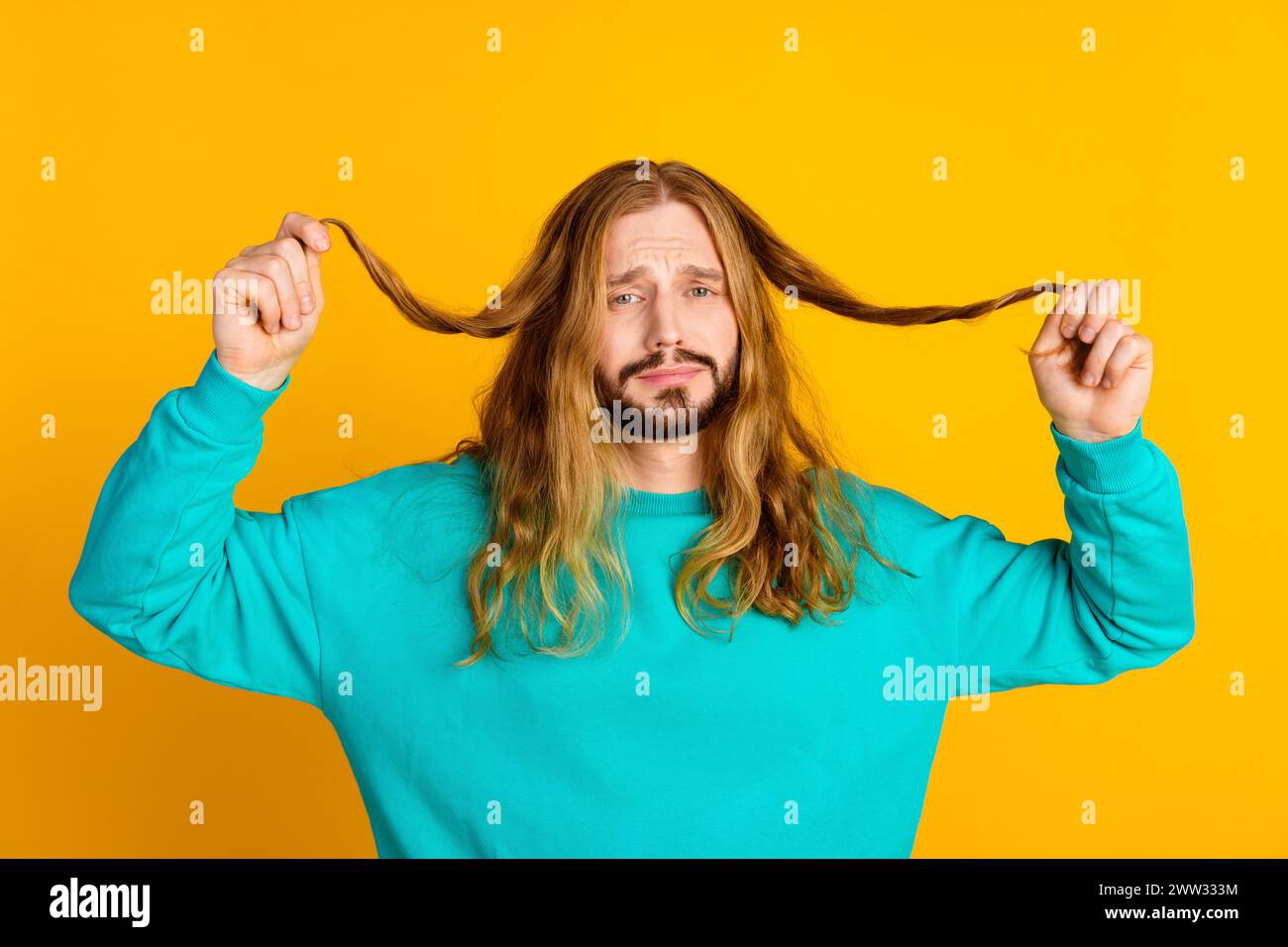 Portrait of disappointed person sullen face arms hold split hair ends ...