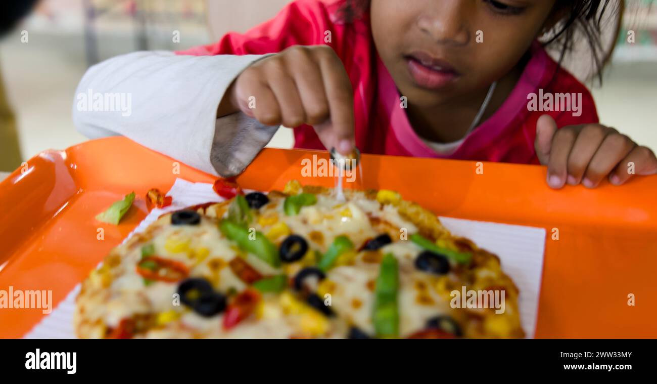 A close-up photo of a young girl with a look of pure enjoyment on her ...