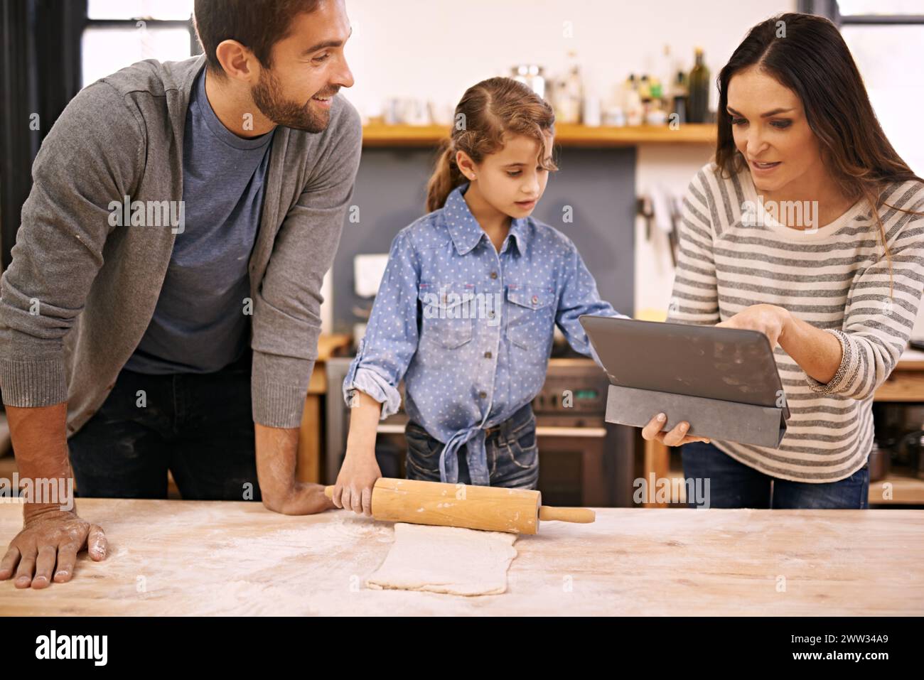 Family, learning and cooking in kitchen with tablet for recipe, guide ...