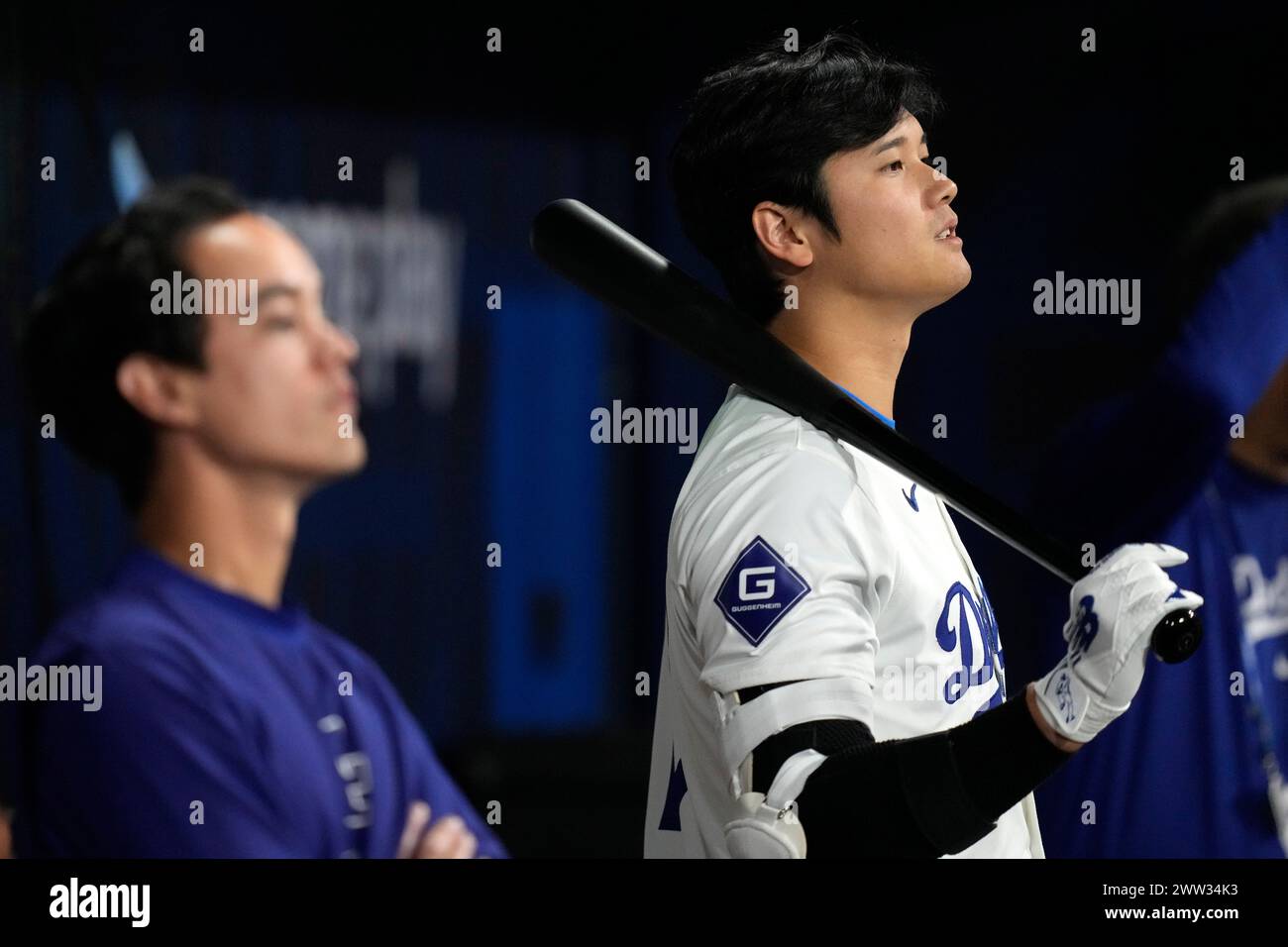 Los Angeles Dodgers designated hitter Shohei Ohtani, right, stands in ...