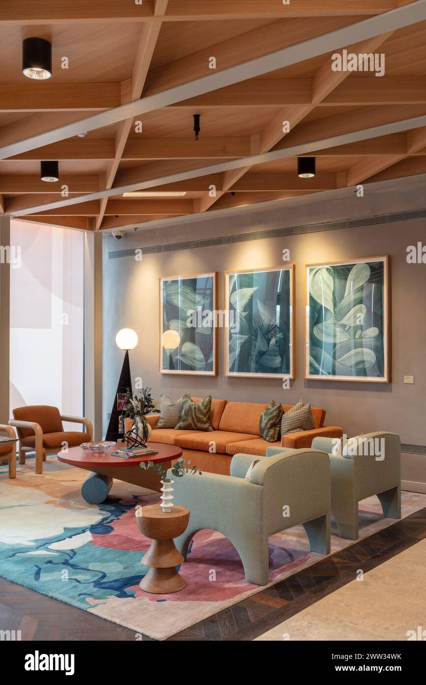 Communal living space with nicely styled seating and art on display ...