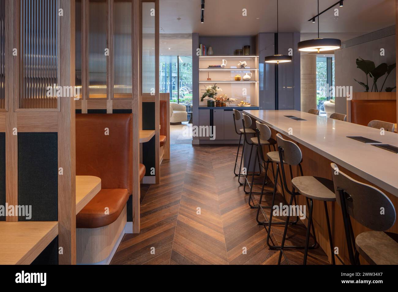 Communal breakfast area, including booths and a larger dining table ...