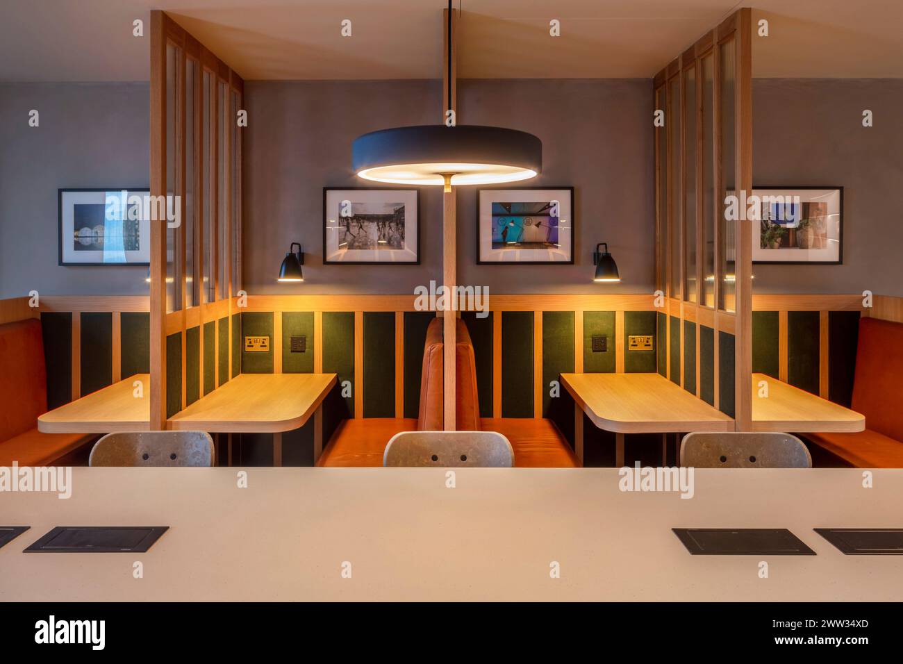 Communal breakfast area, including booths and a larger dining table ...