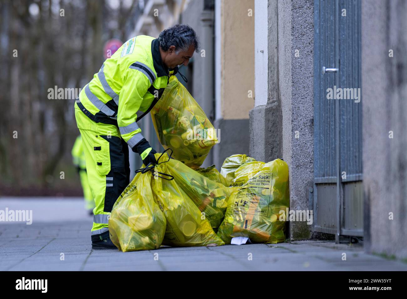 Munich, Germany. 21st Mar, 2024. An employee of the waste disposal ...