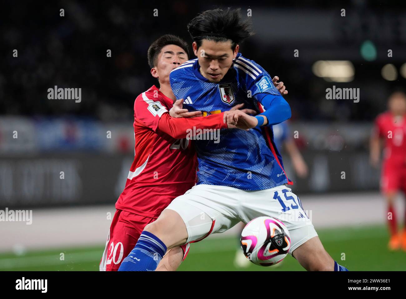 Japan's Koki Machida, right, competes for the ball with North Korea's ...