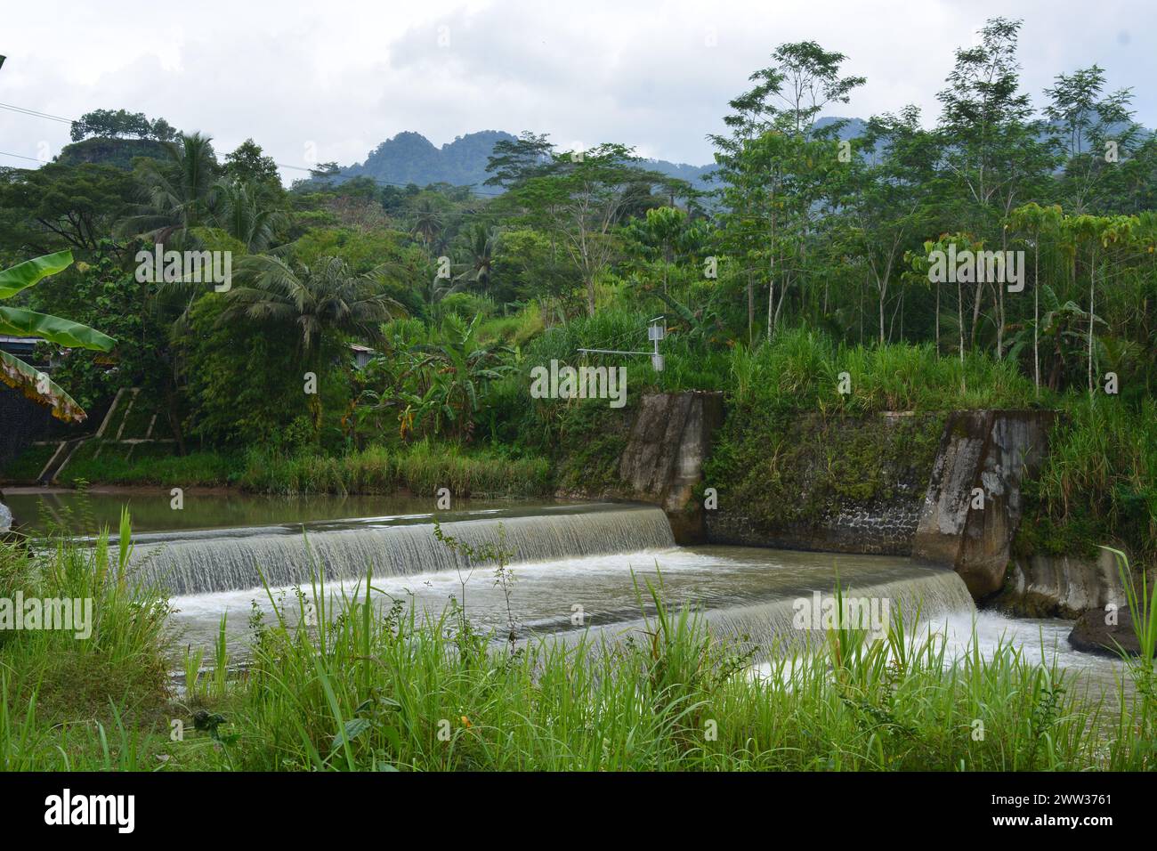 A fast-flowing stream and dramatic lenticular clouds against a dark sky ...