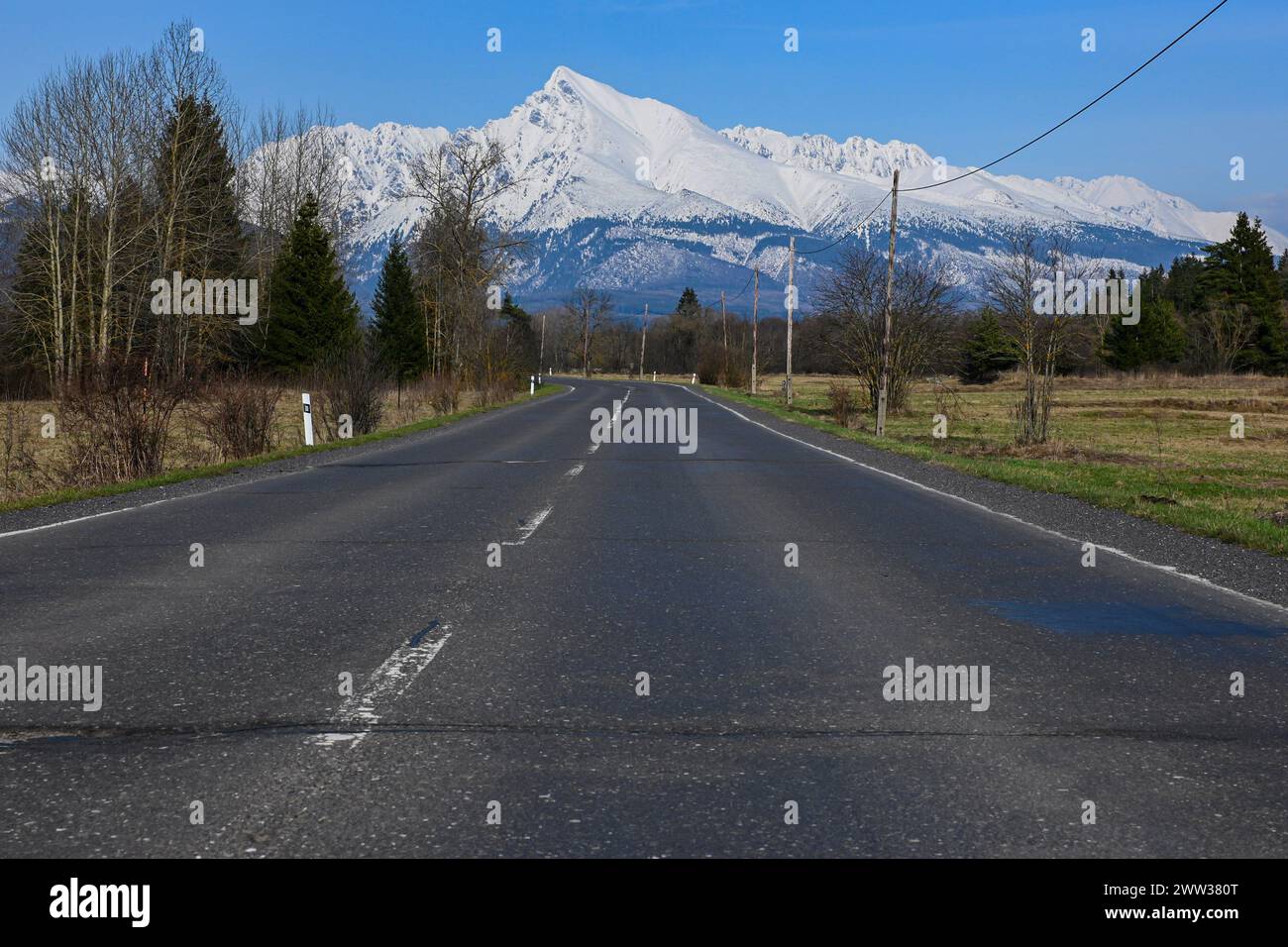 road with a view of the snow-covered mountains (High Tatras - Krivan ...