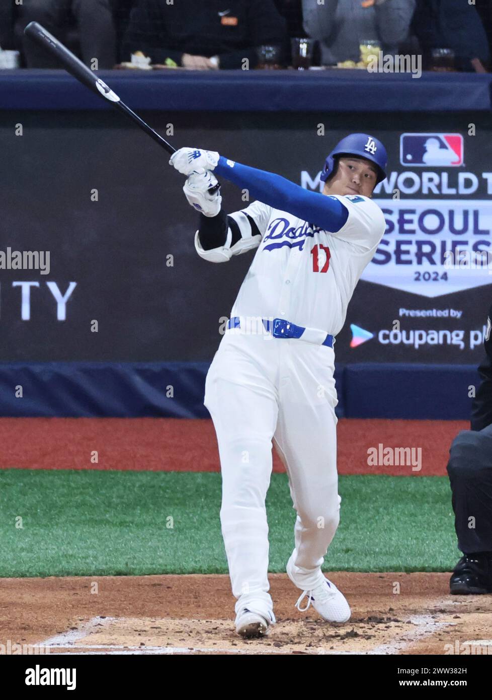 Shohei Ohtani of the Los Angeles Dodgers makes a base hit in the first inning of the MLB game ...
